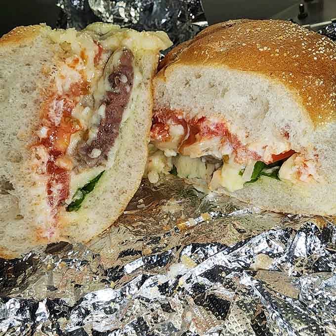 The cross-section reveals the secret: impossibly moist beef and flowing cheese that's infiltrated every delicious crevice like a dairy mission.