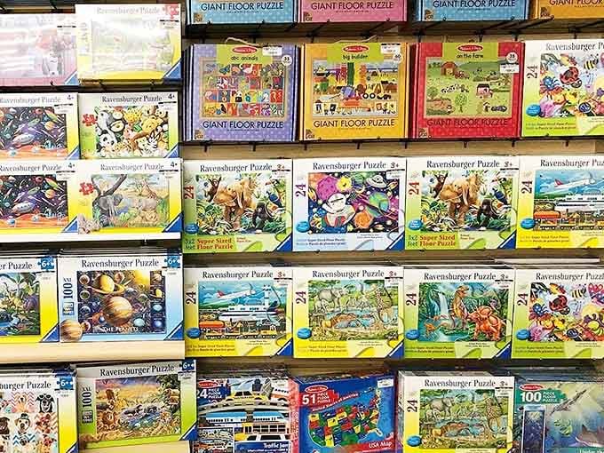 Ravensburger puzzles stacked like treasure, each box promising hours of screen-free satisfaction for sharp minds everywhere.