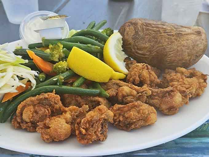 Golden fried oysters paired with a baked potato because sometimes surf needs turf's starchy sidekick for complete happiness.