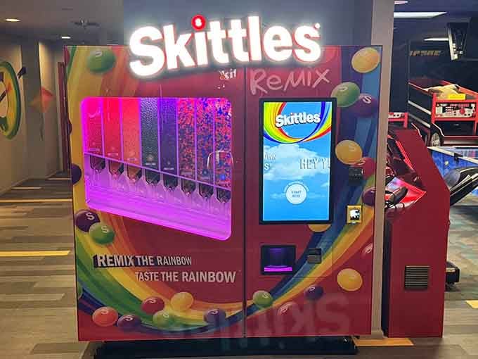 A Skittles dispenser that lets you taste the rainbow between frames, because why choose between fun activities?