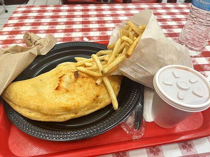The calzone sits there like a golden pillow of happiness, just waiting to burn your mouth deliciously.
