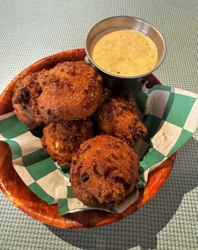 Golden hush puppies with creamy dipping sauce, because some Southern traditions are absolutely non-negotiable around here.