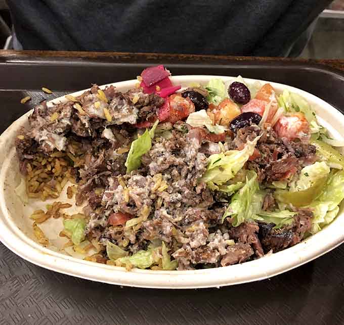 Tender shawarma over seasoned rice, this plate delivers comfort food that actually earns the title without question.