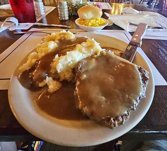 Salisbury steak swimming in rich gravy with a mountain of mashed potatoes is basically a warm hug on a plate.