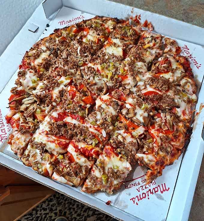 Those green peppers aren't just toppings; they're flavor bombs scattered across a canvas of melted cheese and crispy perfection.