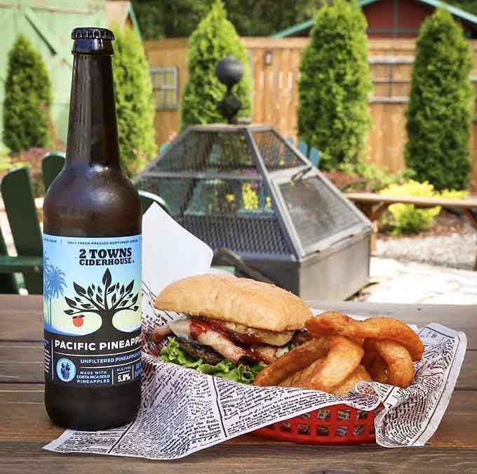 Golden onion rings circling a burger like a delicious halo, proving that some things really are better with a ring on them.