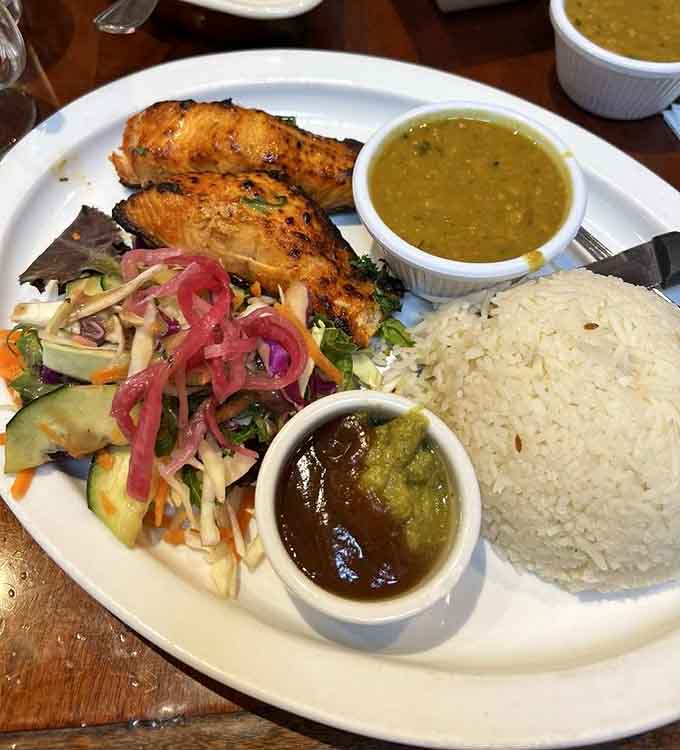 Salmon tikka proves the tandoor oven doesn't discriminate, treating fish with the same smoky reverence as meat.