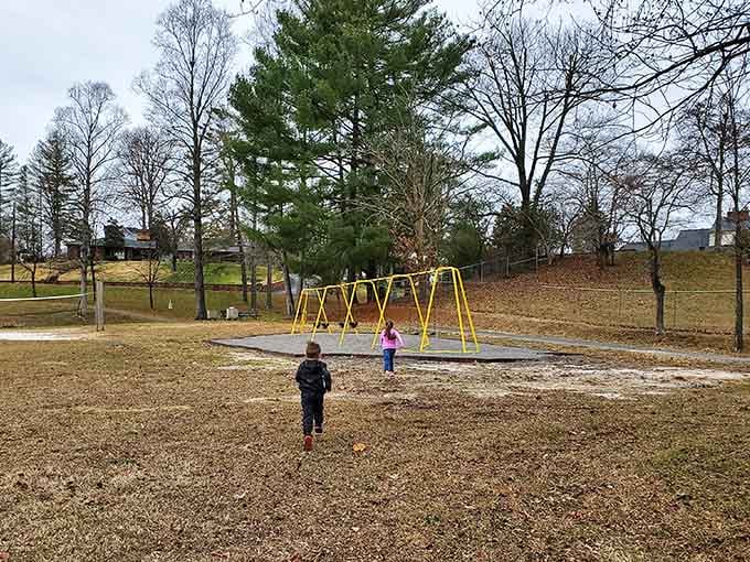 Yellow swings await grandkids in a simple park where childhood joy costs nothing but creates priceless memories together.