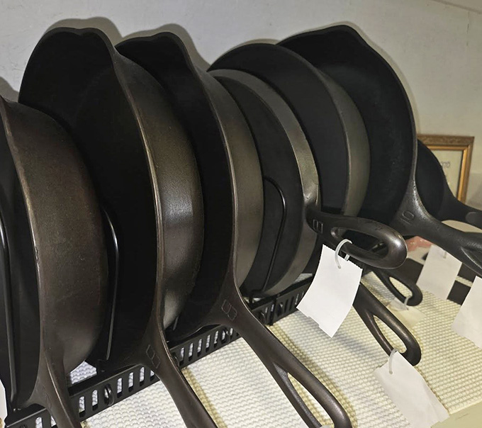 Cast iron skillets lined up like soldiers, each one seasoned with decades of family dinners and stories.