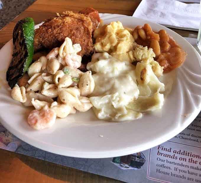 A buffet plate loaded with fried chicken, mac and cheese, and all the comfort food hits.
