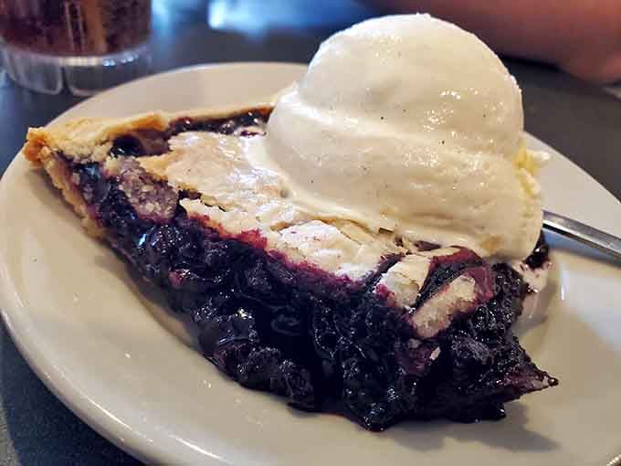 Blueberry pie so loaded with fruit it looks like someone captured summer in a crust and refused to let go.