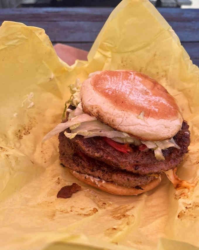 That double-stacked beauty with its glistening bun could make a vegetarian reconsider their life choices, at least momentarily.