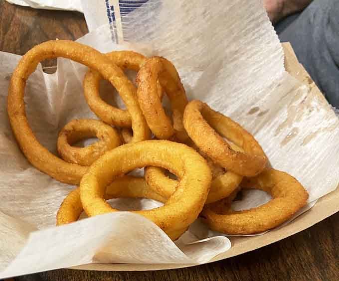 Golden onion rings piled high, crispy circles of fried perfection that deserve their own fan club and possibly a parade.