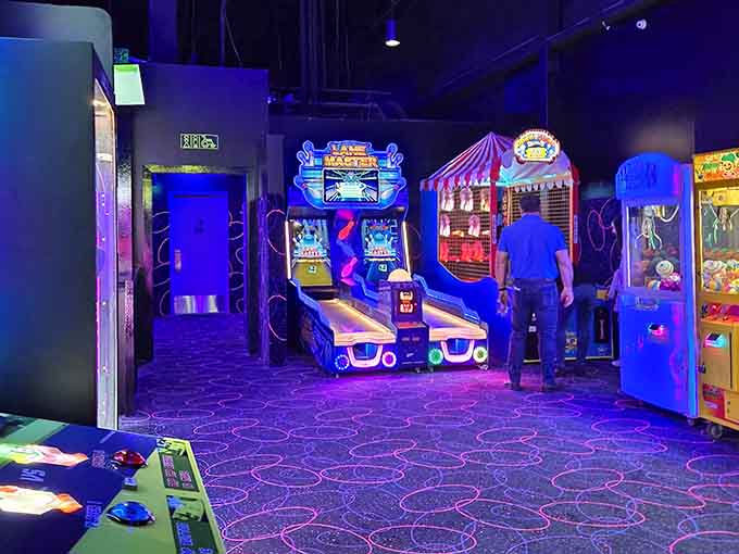 The arcade stretches into purple-hued infinity, promising hours of entertainment beyond the golf course itself.