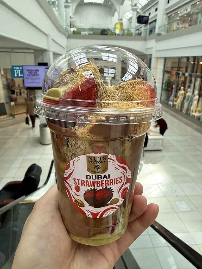 Dubai strawberries topped with kataifi that look like they're wearing fancy golden hats to a very delicious party.