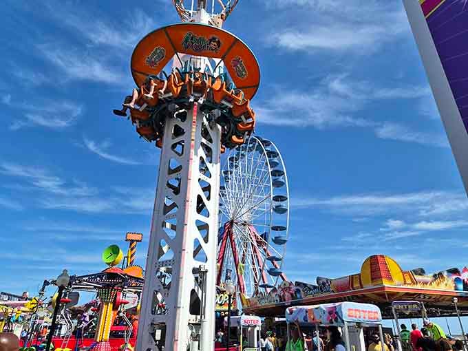 Thrill rides reach for the sky while the Ferris wheel spins stories of summer into the clouds.