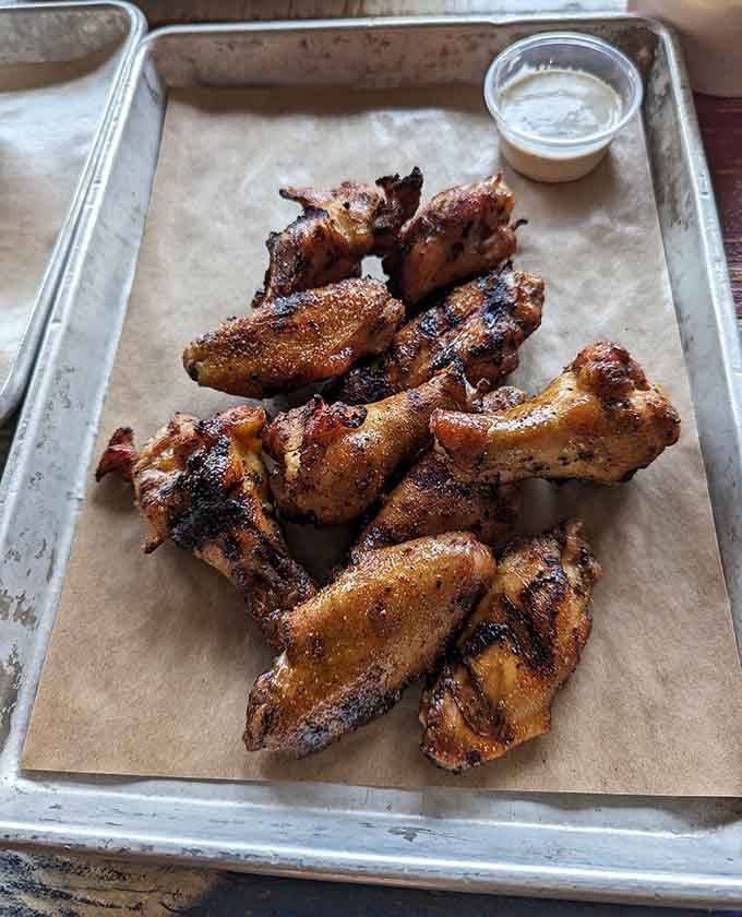 Smoked wings with that golden-brown char prove chicken doesn't have to play second fiddle at barbecue joints.