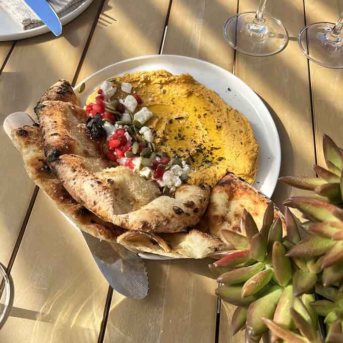 Wood-fired flatbread that looks like it belongs in a food magazine, not your average winery menu.