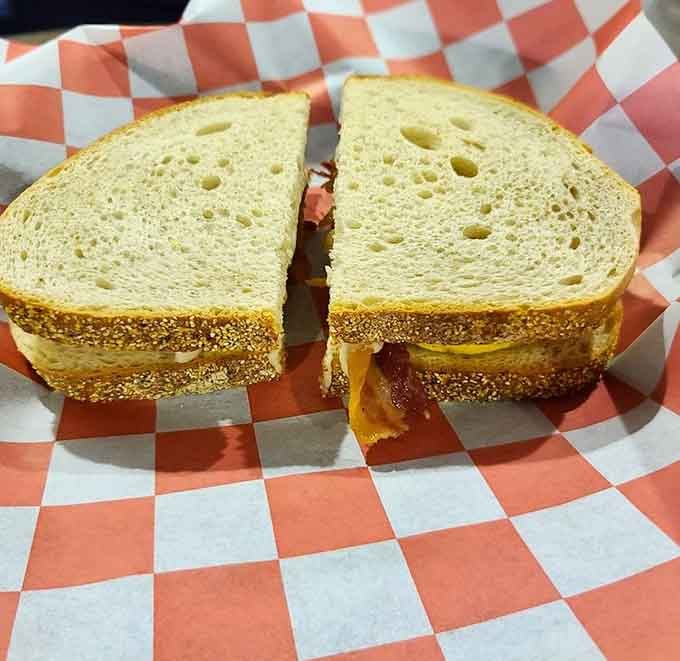 A perfectly grilled sandwich on a checkered basket is comfort food elevated to an art form.