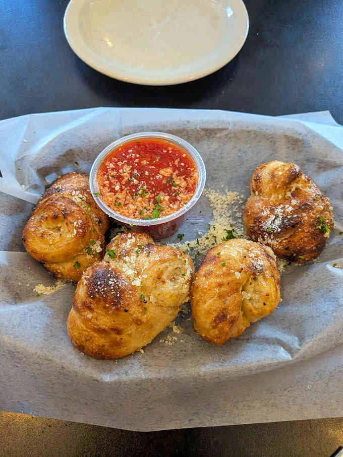 These garlic knots are basically edible pillows of joy, served with marinara for maximum happiness.