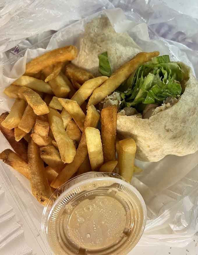 That Caesar wrap looks like it's been hitting the gym, packed with crisp romaine and golden fries for good measure.