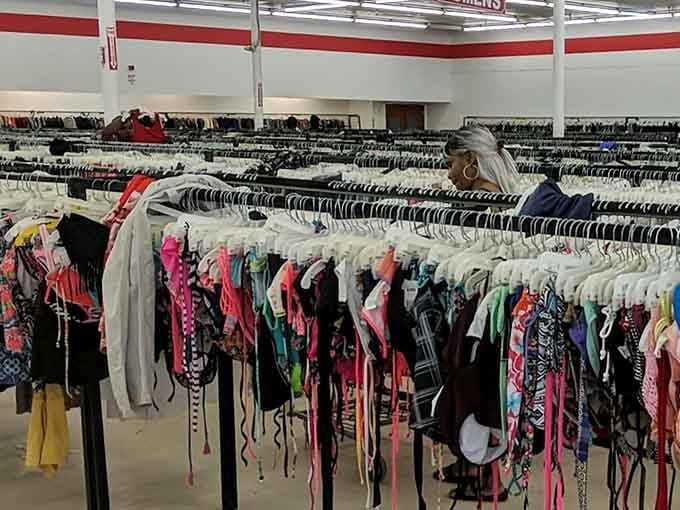 Rows of clothing stretch into the distance like a fabric horizon, promising treasures for those willing to hunt for them.