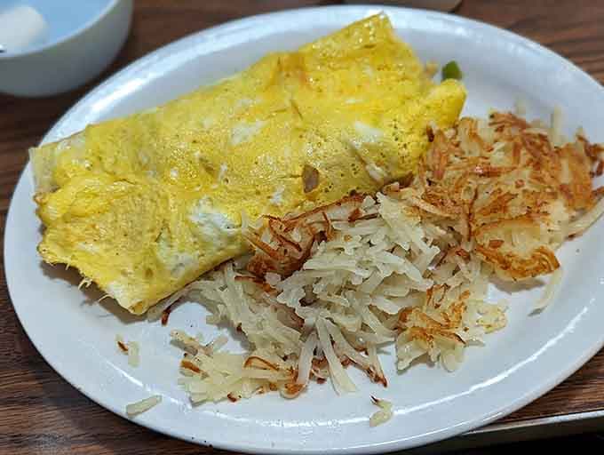 That omelet is stuffed fuller than your uncle's Thanksgiving plate, with hash browns providing the perfect crispy sidekick.