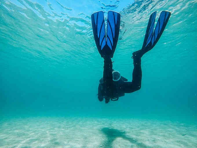 That first plunge into crystal-clear quarry water is like stepping through a portal to another dimension.