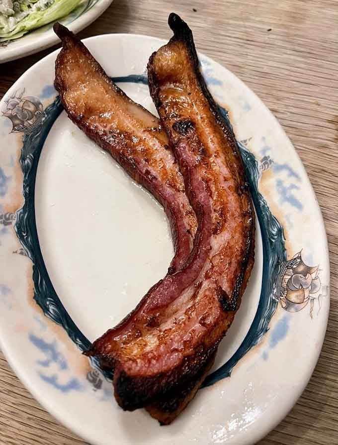 Two strips of thick-cut bacon that could double as a main course at lesser establishments.