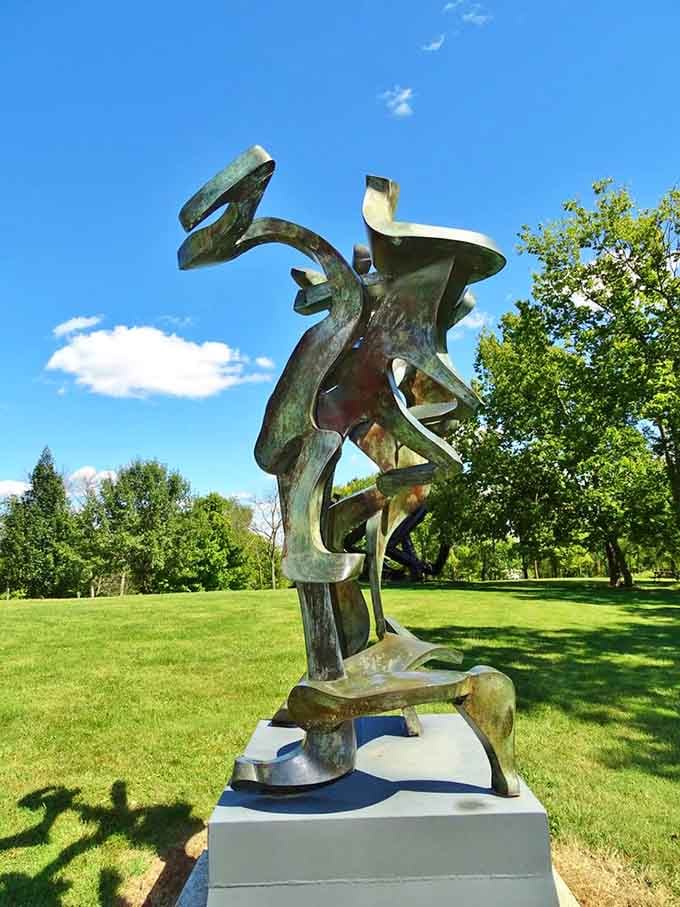 Weathered bronze twists upward with the grace of a dancer frozen mid-pirouette against blue skies.