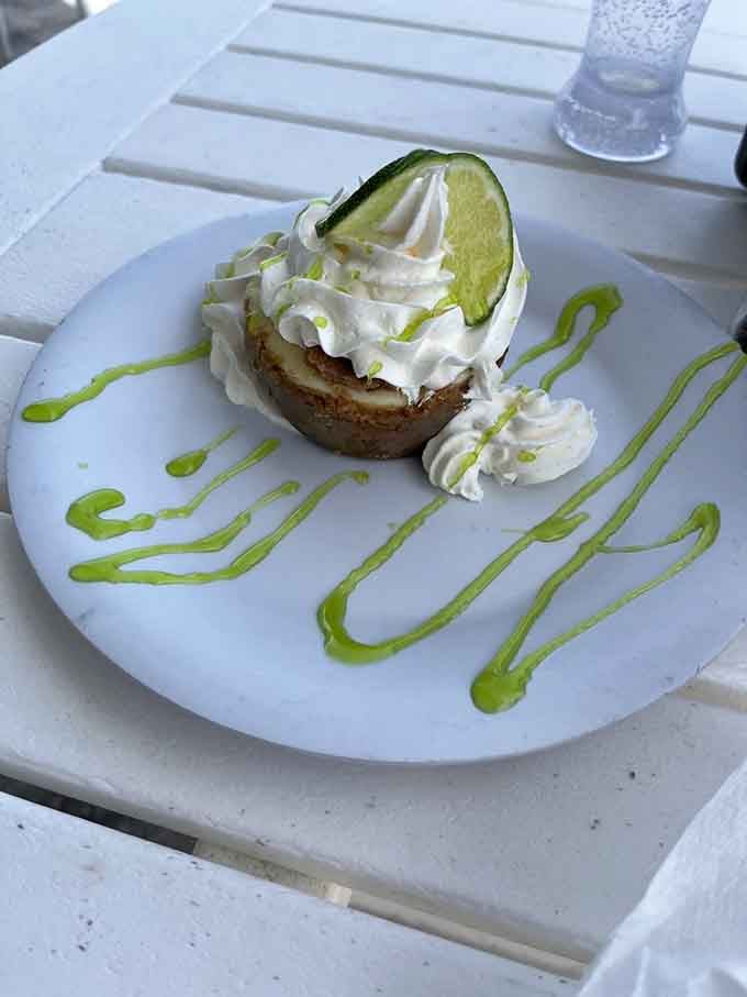 Key lime pie topped with whipped cream and a lime slice, because Florida desserts don't mess around with subtlety.