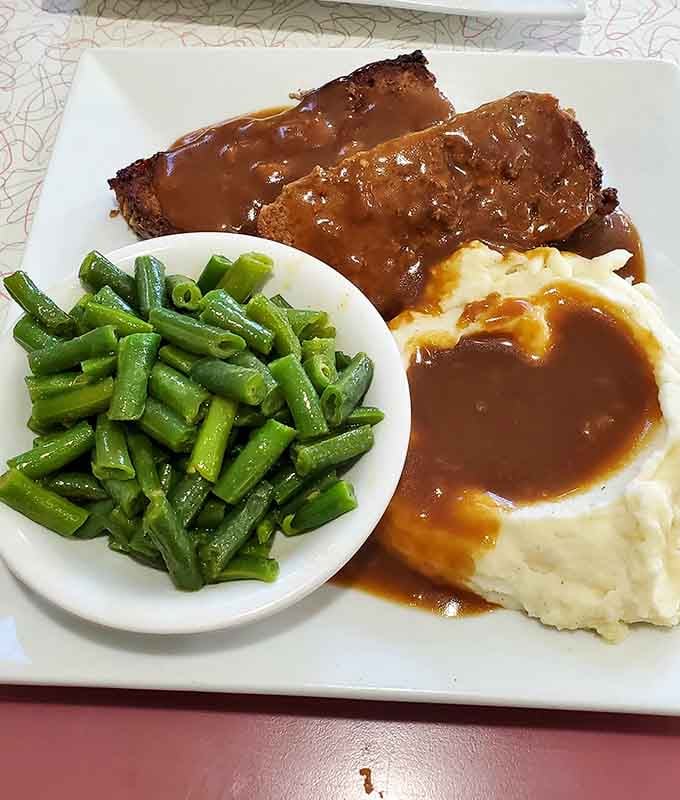 Meatloaf, mashed potatoes, and green beans: the holy trinity of comfort food done absolutely right here.