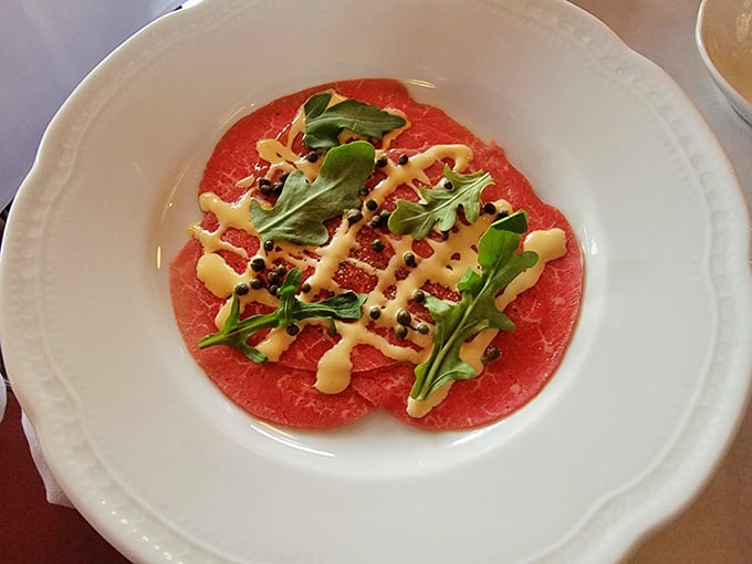 Carpaccio so delicate it practically melts on contact, topped with arugula and shaved cheese that knows its purpose.