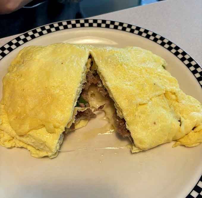 That omelette is stuffed so generously it practically needs its own zip code and passport.