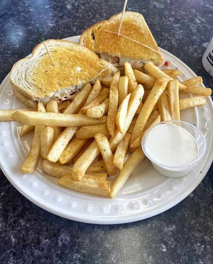 Melted crab on toasted bread with a side of crispy fries is the coastal lunch your taste buds deserve.