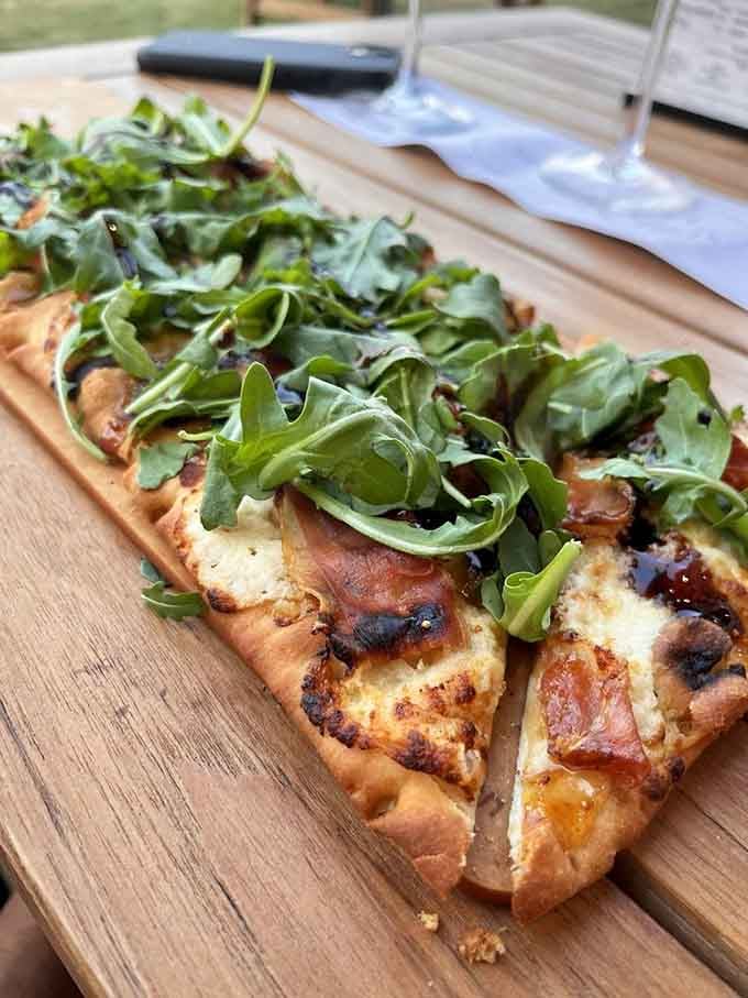 Fig, prosciutto, and arugula on flatbread&mdash;proof that pizza's sophisticated cousin came to visit and never left.