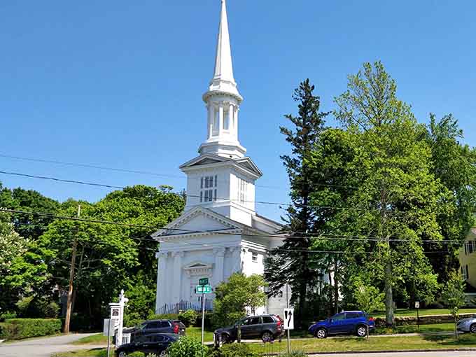 The white steeple rises above the trees like a beacon for anyone seeking classic New England charm and excellent photo opportunities.