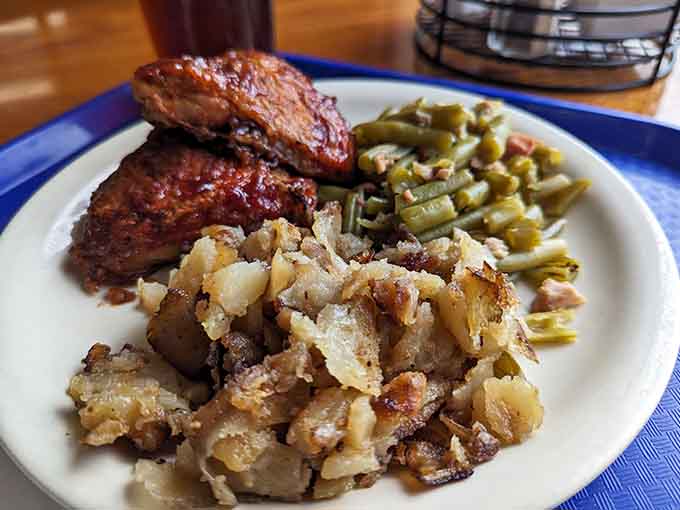 Glazed baked chicken with crispy hash browns and green beans shows buffets can be beautiful when done properly.