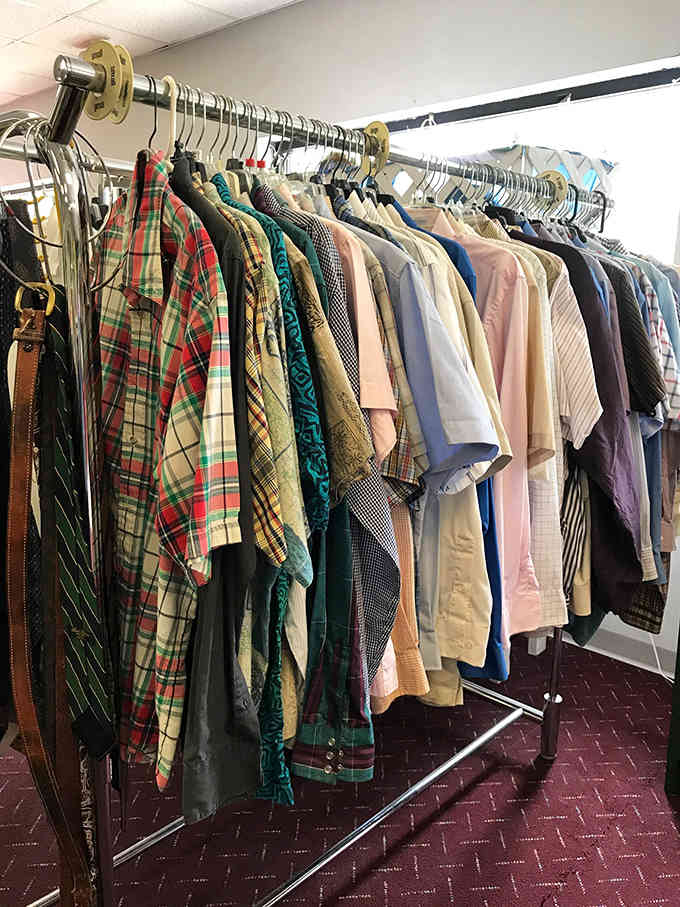 Plaid flannel shirts hang alongside classic button-downs, offering timeless style without the department store sticker shock that hurts.