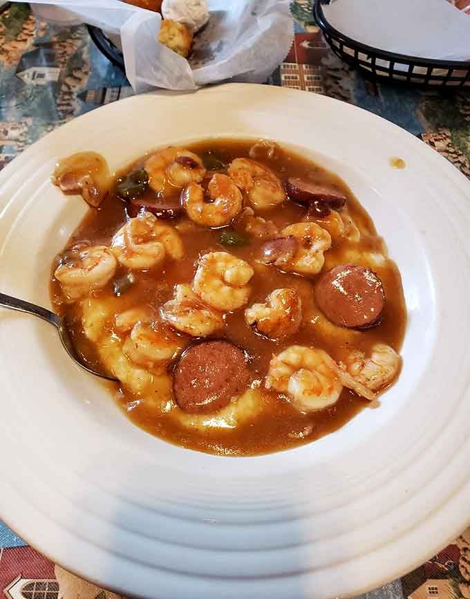 Shrimp and grits swimming in rich gravy with sausage is pure Lowcountry soul food magic.