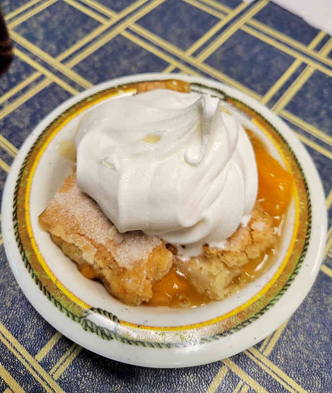 Peach cobbler topped with whipped cream is the sweet finale your meal deserves, no arguments accepted here.