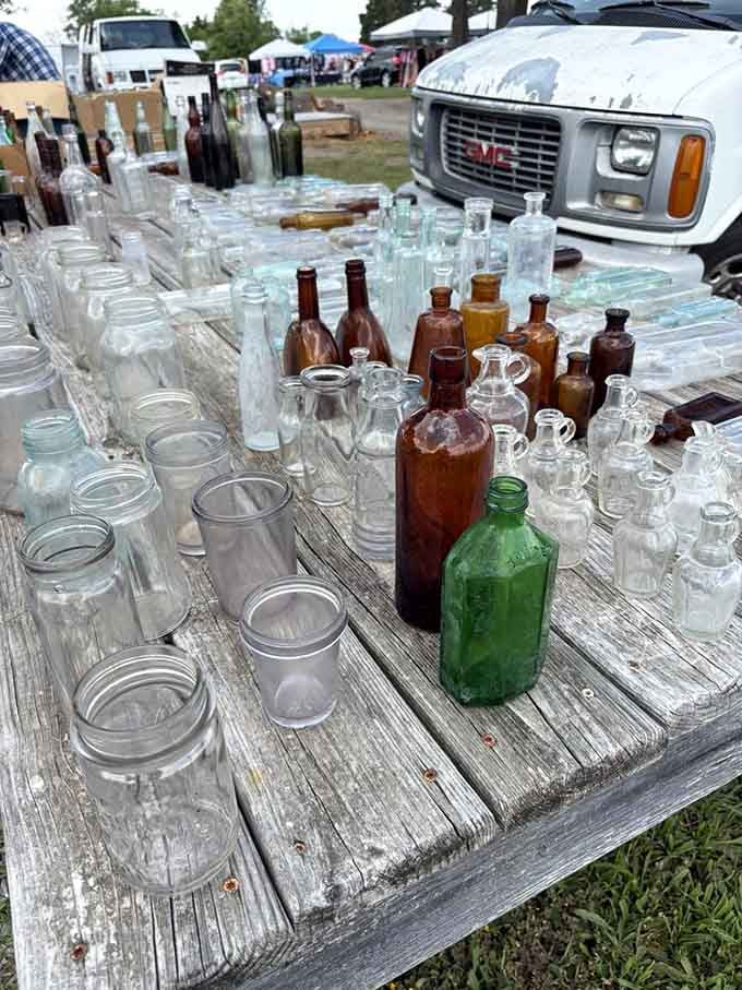 Vintage bottles lined up like glass soldiers, each one holding stories from decades past in their curves.