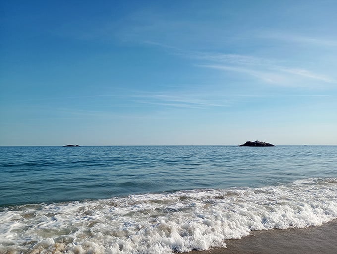 Foamy waves roll toward shore like nature's own cappuccino, complete with that satisfying rhythmic soundtrack.