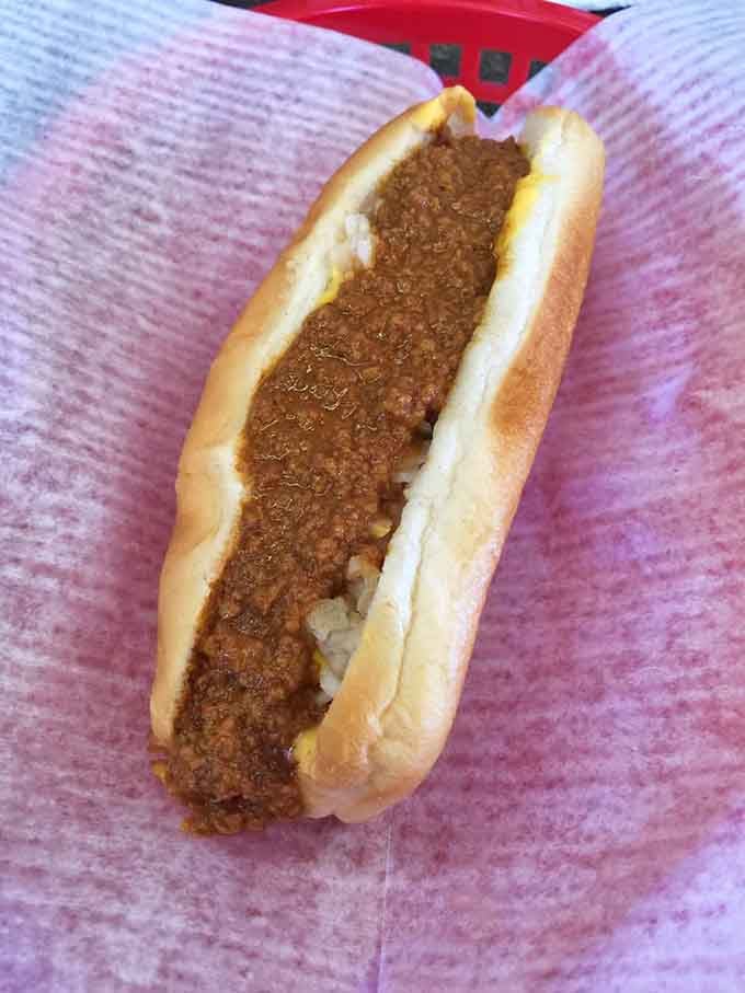 That chili blanket covering the dog looks like it's been perfected over decades of happy customers and secret recipes.