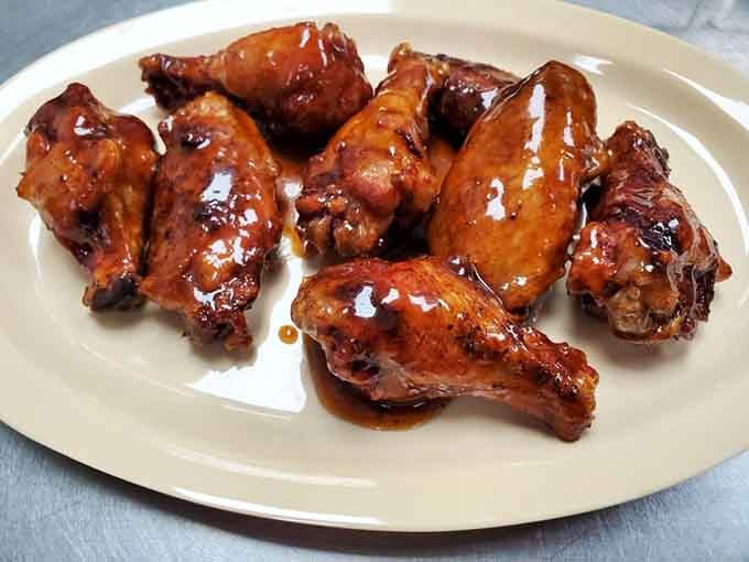 Wings glazed to glossy perfection, ready to make you forget every other chicken wing you've ever eaten.
