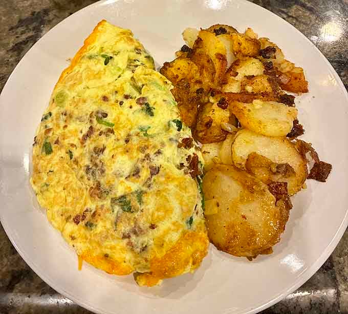 This omelet is stuffed so generously, it practically needs its own zip code on the plate.