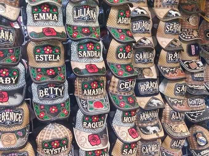 Personalized caps create a mosaic of names and flowers, each one waiting to crown someone's head with custom flair.