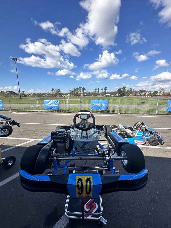 The driver's view from kart number 90 shows serious engineering beneath that sporty blue bodywork and racing seat.