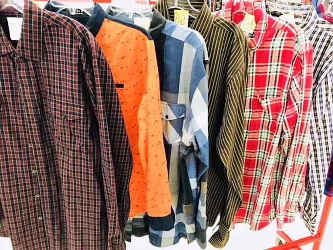 Plaid, stripes, and polka dots coexist peacefully on hangers, waiting for their second chance at fashion glory.