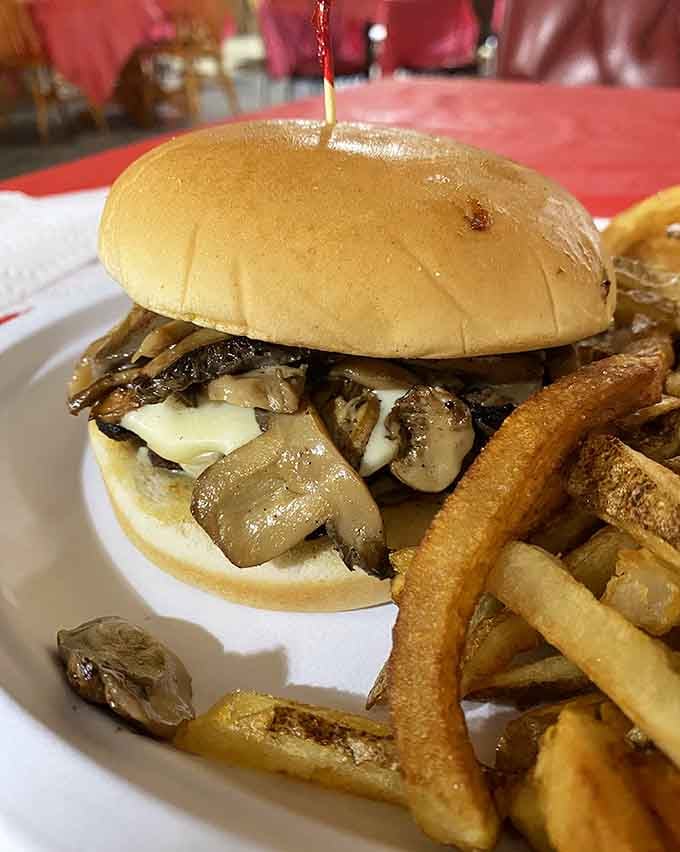 That mushroom swiss burger towers like a delicious skyscraper, and you'll need an engineering degree to eat it gracefully.